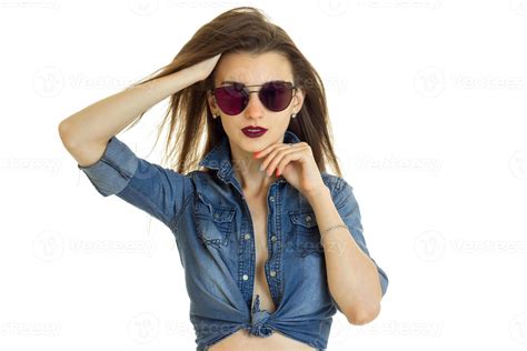 Hot Lady In Jeans Jacket Without Bra Looks At The Camera In Sunglasses