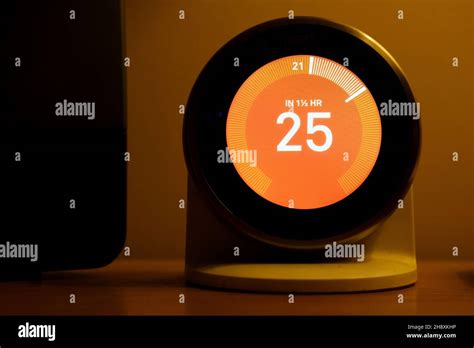 A Nest Home Heating Smart Learning Thermostat Situated In A House And Set To Increase The Heat