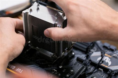 Technician Man Installs Air Cooled Heatsink On Microprocessor Covered With Heatsink Paste Technician Man Installs Air Cooled Heatsink On Microprocessor Covered With Heatsink Paste