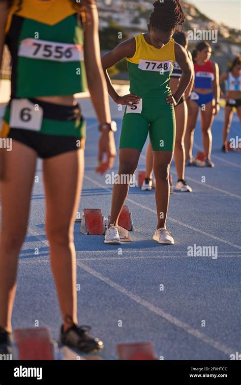 Female Track And Field Athletes Preparing At Starting Blocks Stock Photo Alamy
