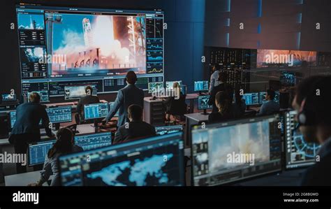 Group Of People In Mission Control Center Witness Successful Space