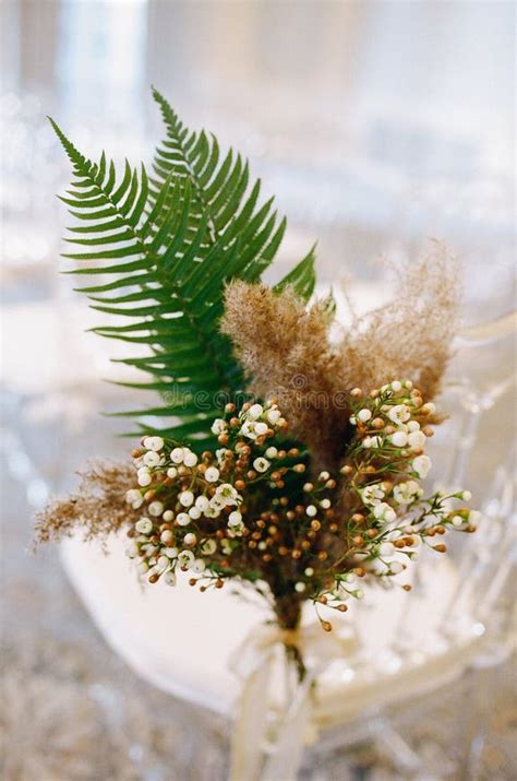 Elegant Floral Arrangement Featuring Ferns And Delicate Flowers For A