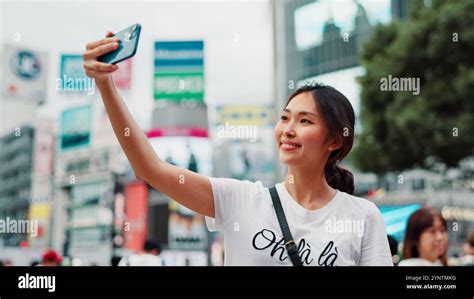 Japanese Woman Selfie And Smile In City With Live Streaming Of Vlogger