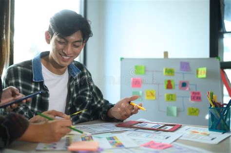 Cheerful Young Man Collaborating With His Team On App Design And Ui Ux