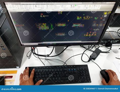 Electrical Draftsman Working On The Computer Monitor With Typing Keyboard And Mouse Stock Image