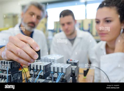 Teacher Connecting Electronics Circuit As Babes Look On Stock Photo Alamy