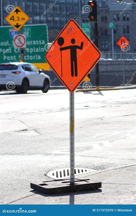 Red Caution Sign At Road Intersection With Traffic And Other Signs