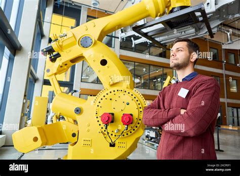 Professional Engineer Supervising An Advanced Industrial Robot With A