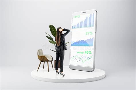 Businesswoman Analyzing Charts On A Giant Smartphone Display Stock
