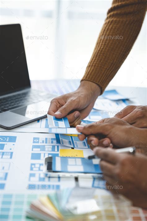 A Group Of Asian Ui Developers Designers And Data Researchers Are Brainstorming Their Projects