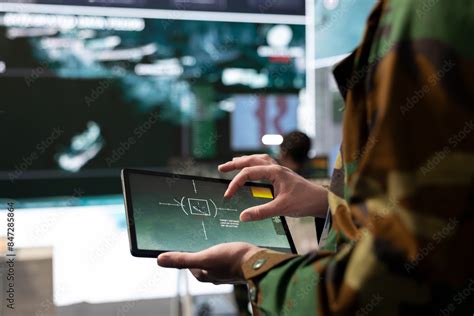 Military It Engineer Collecting Intelligence From World Map Projection Tablet Connected To