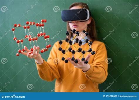 Female Student Wearing Virtual Reality Glasses Holding Molecular Structure Model Science Class