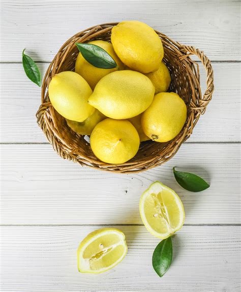 Top View Of Lemons Fruits In Wicker Basket On White Table Lemon