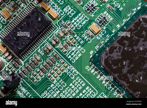 Wet Digital Circuit Board With Microprocessors And Components Closeup