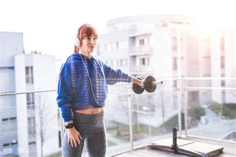 Redhead Woman S Home Workout Routine With Dumbbell At Balcony Home