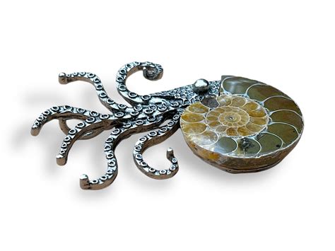 A Silvered Metal Brooch Of A Squid With An Ammonite Fossil Body And Six