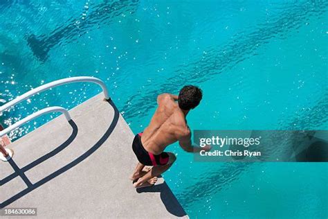 A Diver Standing On A Diving Board Photos And Premium High Res Pictures