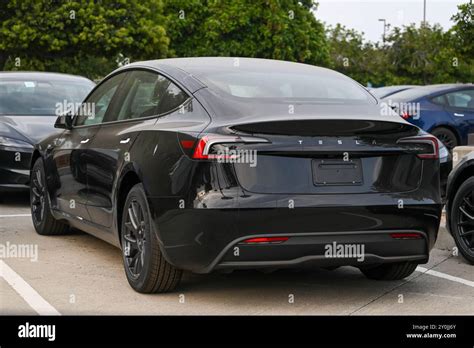 Tesla Model 3 Vehicles Are Stored In A Parking Lot At San Bernardino
