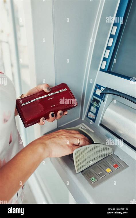 Woman Withdrawing Money From Atm Machine Using Debit Or Credit Card