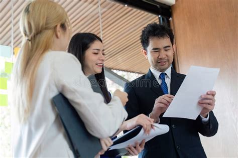 Diverse Business Team Collaborating In A Modern Office Reviewing