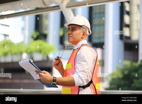 Portrait Of Multiethnic Architect With Blueprints And Business Industrial Man Engineer At