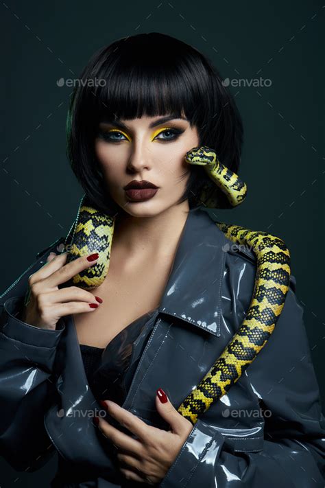 Beauty Woman Python Yellow Snake Around Her Neck On Latex Shiny Raincoat Yellow Snake Stock