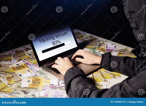 anonymous hacker programmer uses a laptop to hack the system in the