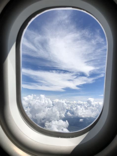 Aerial View Of Clouds From Airplane Window View From The Plane View
