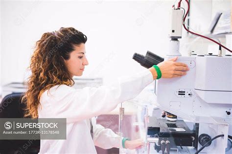 Female Scientist Using Ftir Spectrophotometer Focusing Sample On