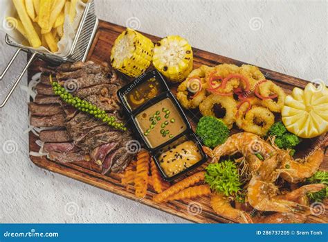 Surf And Turf Platter Filled With Grilled Seafood And Steaks