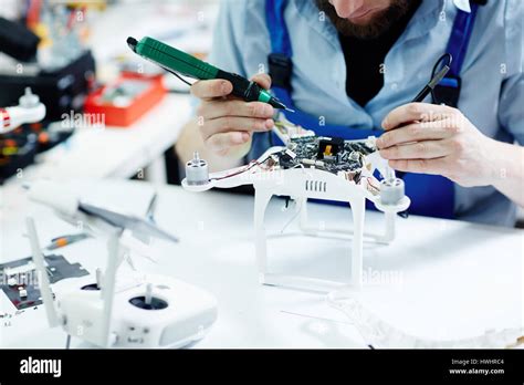 Closeup Shot Of Unrecognizable Man Testing Electric Current In Circuit Board Of Disassembled