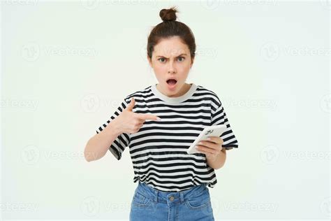 Angry Woman Complaining Pointing At Smartphone And Shouting With Frustrated Face Expression