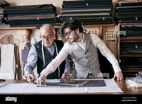 A Tailor And A Younger Man An Assistant Or Apprentice Working Together