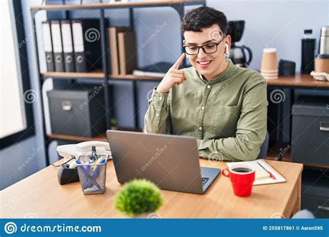 Non Binary Person Working At The Office Wearing Glasses Smiling Happy