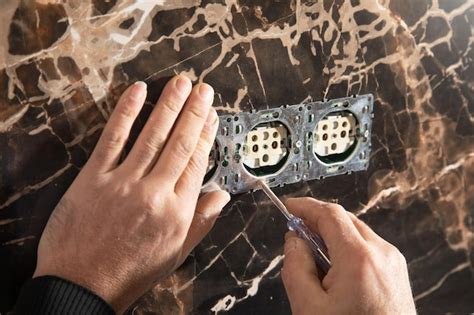 Premium Photo Electrician Installing A Wall Socket At Home
