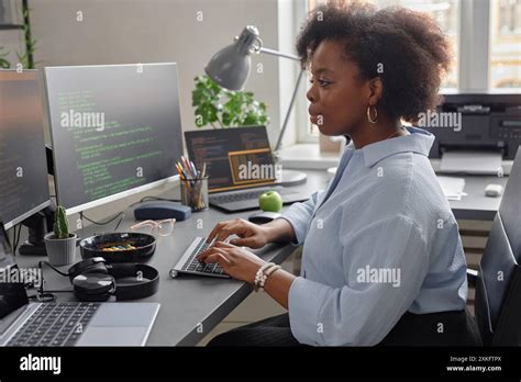 Side View Of Young African American Female Software Developer Using