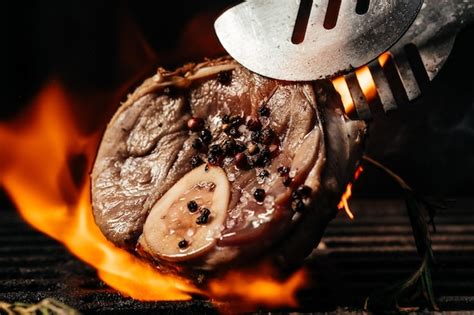 Premium Photo Beef Steaks Pieces Of Meat On The Grill With Flames