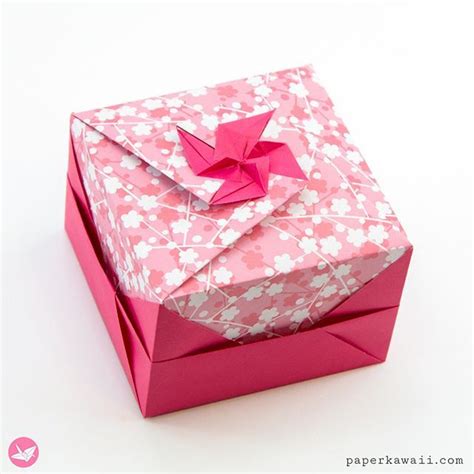 An Origami Box With A Pink Bow On Top