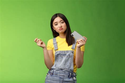 Premium Photo Beautiful Young Woman Standing Against Green Background