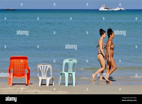 Two Female Western Tourists Walk Along Patong Beach Phuket Thailand