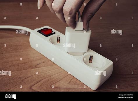 Female Hand Plugging Usb Cable Into Phone Charger Adapter Stock Photo Alamy