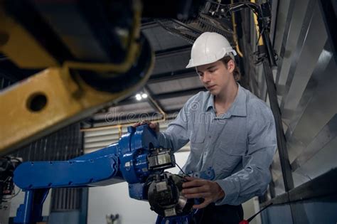 Engineer Standing By Robotic Arm And Operating Machine In Industry Factory Stock Image Image