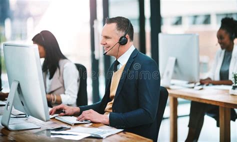 I Aim To Please A Handsome Mature Male Operator Working At His Desk Stock Image Image Of