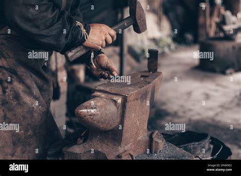 Blacksmith Process Metal With Hammer On Anvil In Forge Farrier In