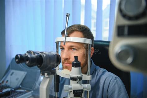 Adult Man Eyesight Test With Binocular Slit Lamp Checking Retina Of A