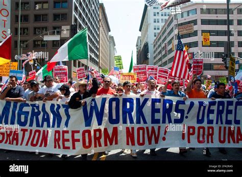 A Crowd Marches With A Large Immigrant Workers Sign During An