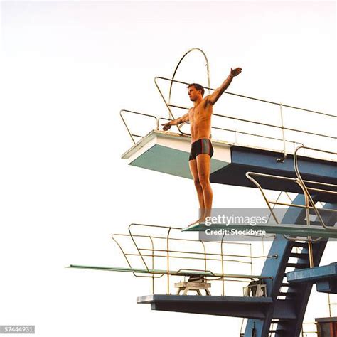 A Diver Standing On A Diving Board Photos And Premium High Res Pictures