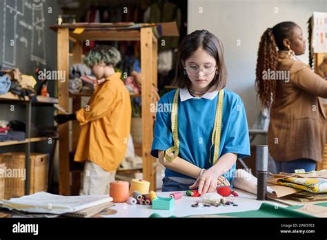 Waist Up Portrait Of Young Girl With Disability Sorting Threads By Color In Sewing Class Copy