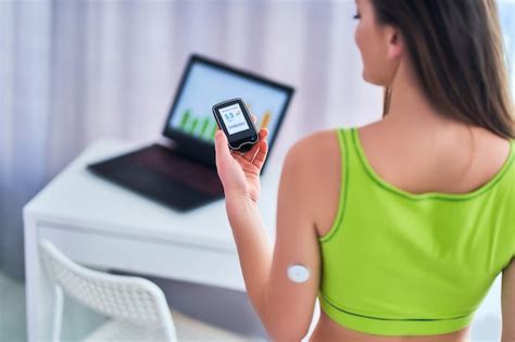 Woman Diabetics Control And Checking Glucose Level With A Remote Sensor