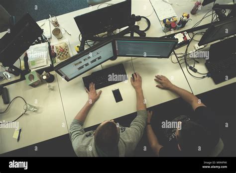 Top View Of Software Developers Writing Programming Code On Computer